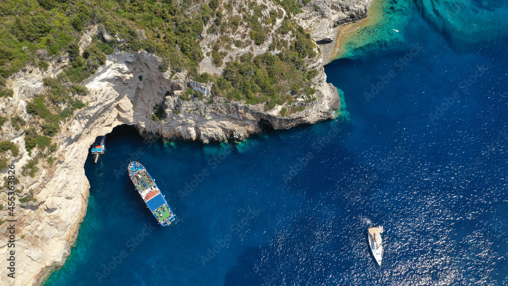 Aerial drone photo of iconic Ortholithos and azure caves with deep ...