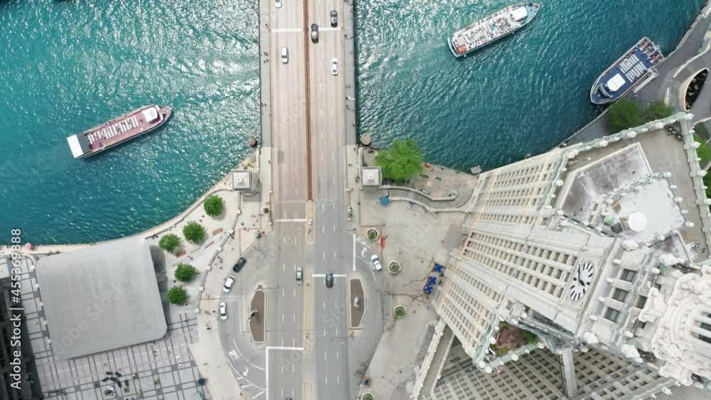 Cinematic aerial bright blue Chicago river and white marble city clock ...