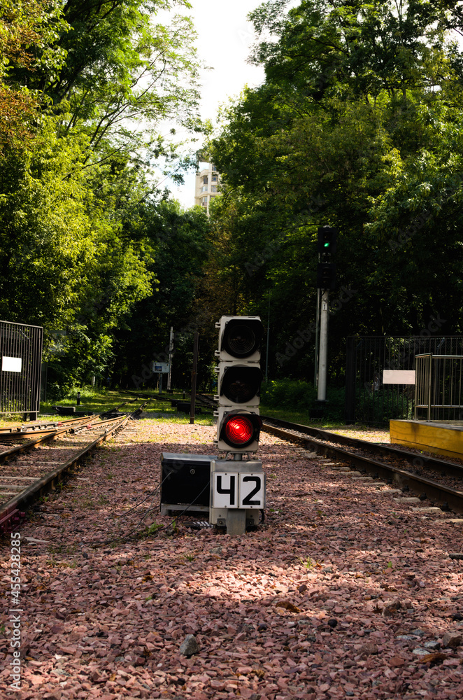 Railway traffic light for the movement of trains is lit in red. Railway ...