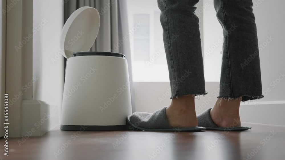 B-roll woman littering a piece of tissue paper into an white bin Stock ...