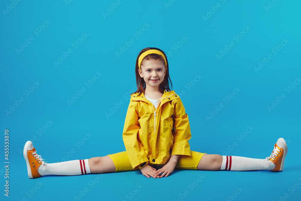 Cute girl child doing splits, stretching exercise, straight angle pose ...