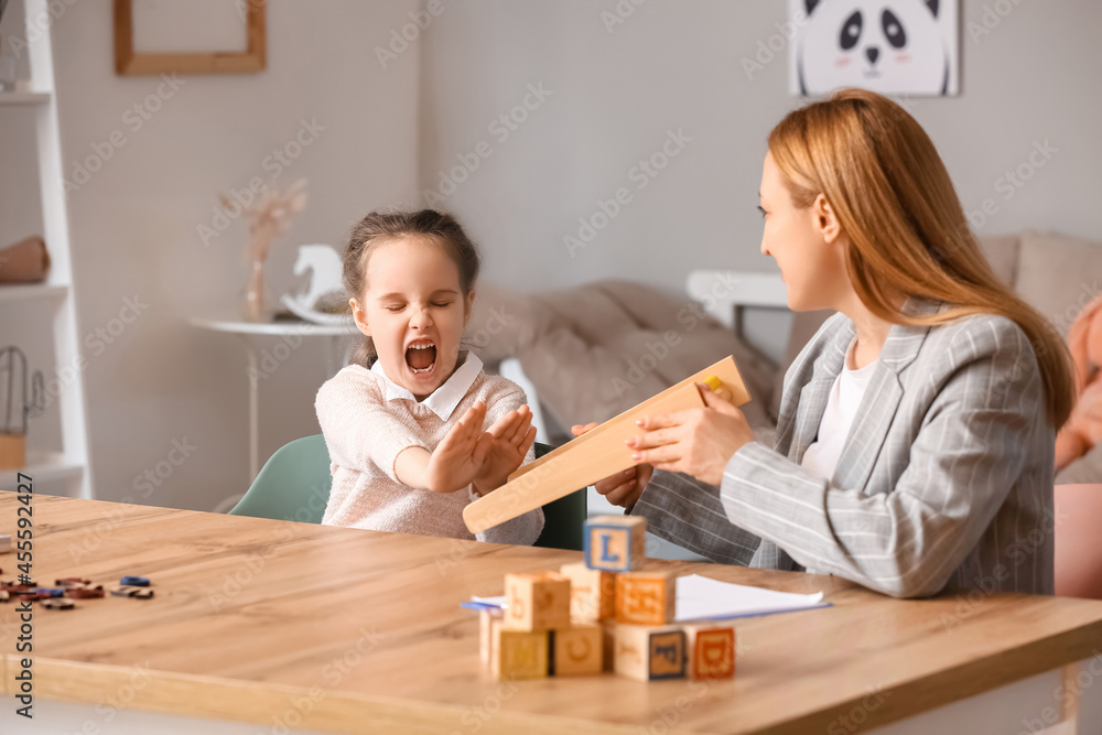 Angry little girl with autistic disorder at child psychologist's office ...