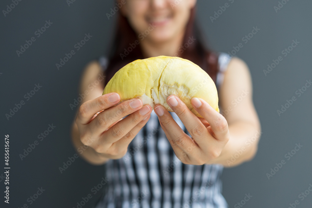 Close up A woman handle durian show the yellow durian meat to eat. The ...