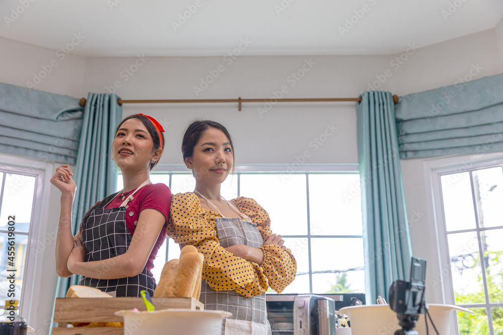 Bakery partnership. Young ladies working together in a kitchen for ...