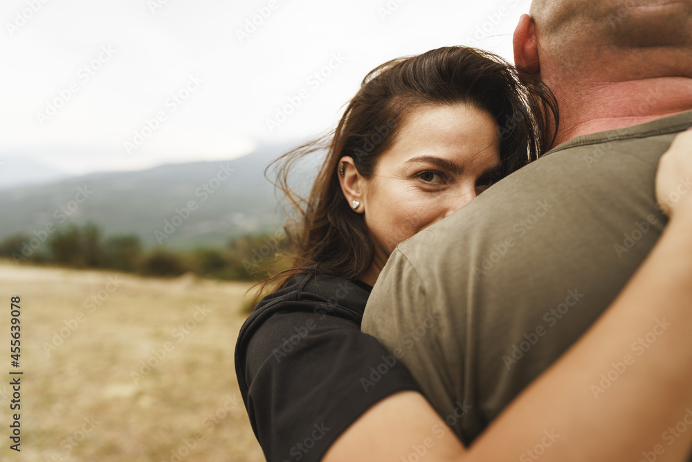 Happy couple in love hugging smiling and having fun in the mountains ...