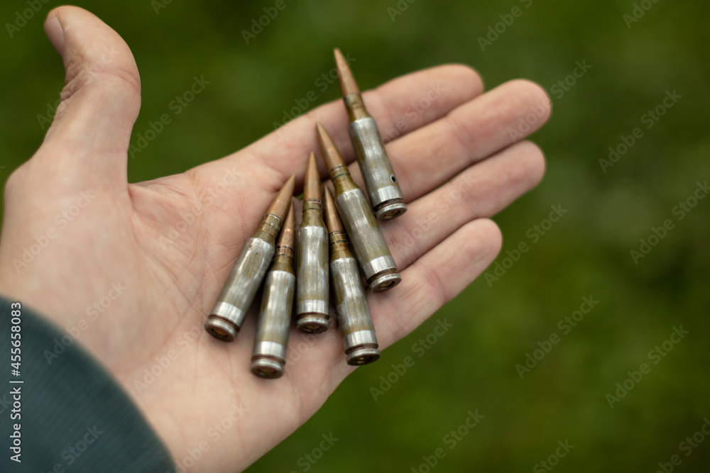 Cartridges in the palm of your hand. Machine gun bullets in the hand ...