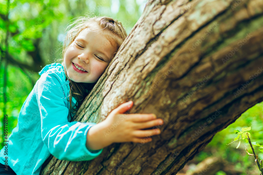 little girl on tree in the summer on nature little girl Stock Photo ...
