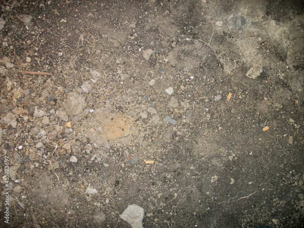 Ground with impurities of rubble, stones, and other debris, top view ...