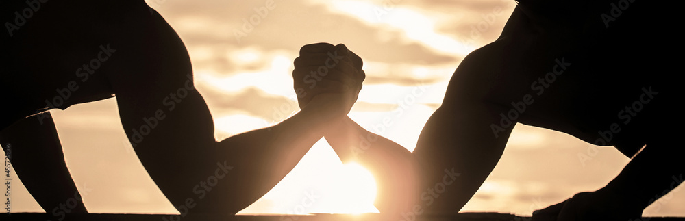 Rivalry, closeup of male arm wrestling. Men measuring forces, arms. Two ...