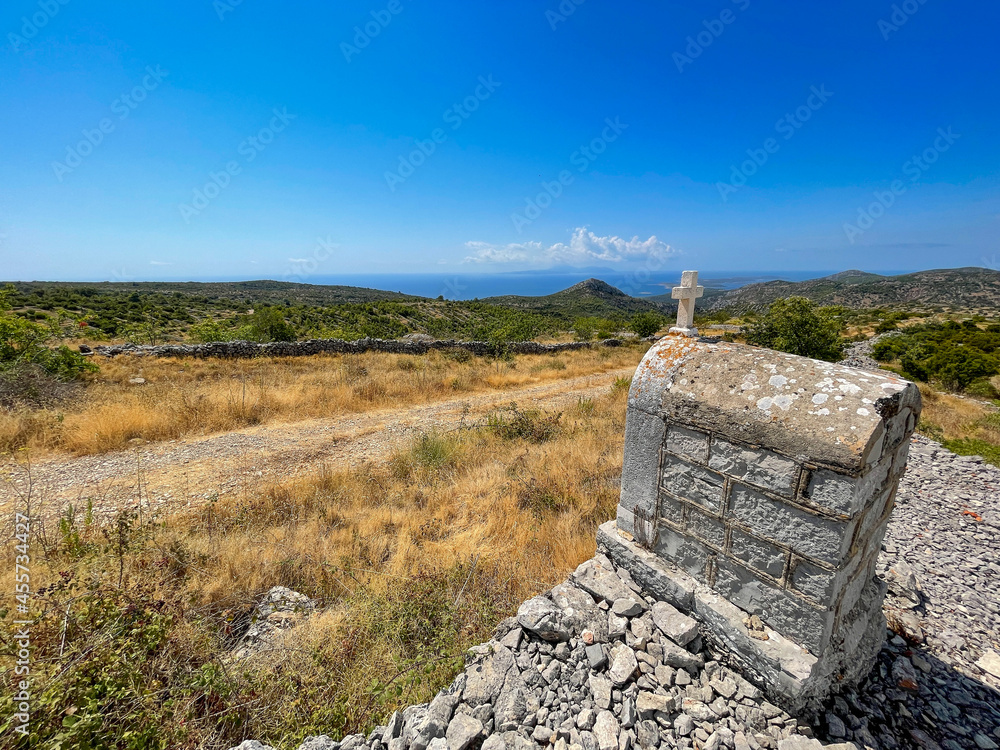 Land parcel marker atop a dry stone wall erected centuries ago on the ...