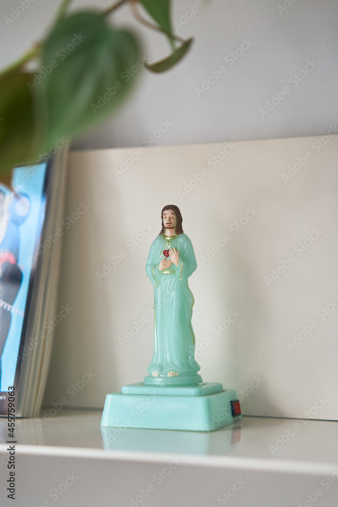 Statuette of Jesus Christ on shelf Stock Photo | Adobe Stock