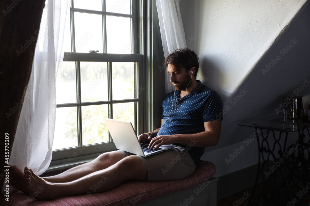 Man working remote on vacation Stock Photo | Adobe Stock