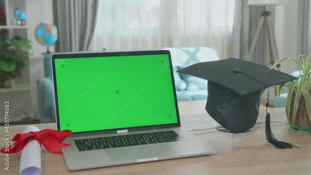 Graduation Cap And Diploma With Mock Up Green Screen Laptop Computer ...