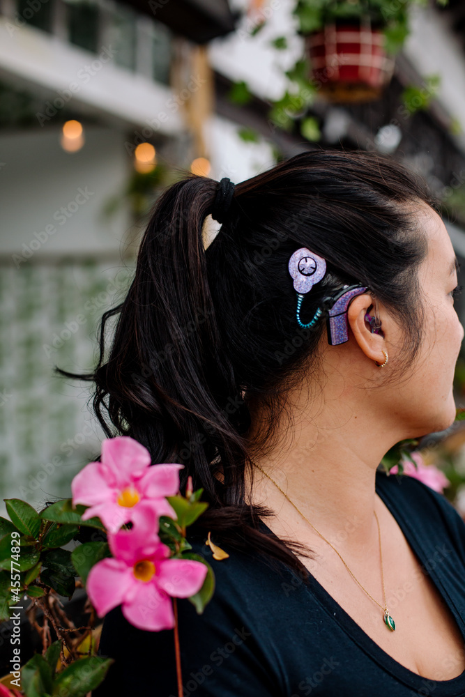 Side view of female with cochlear implant Stock Photo | Adobe Stock