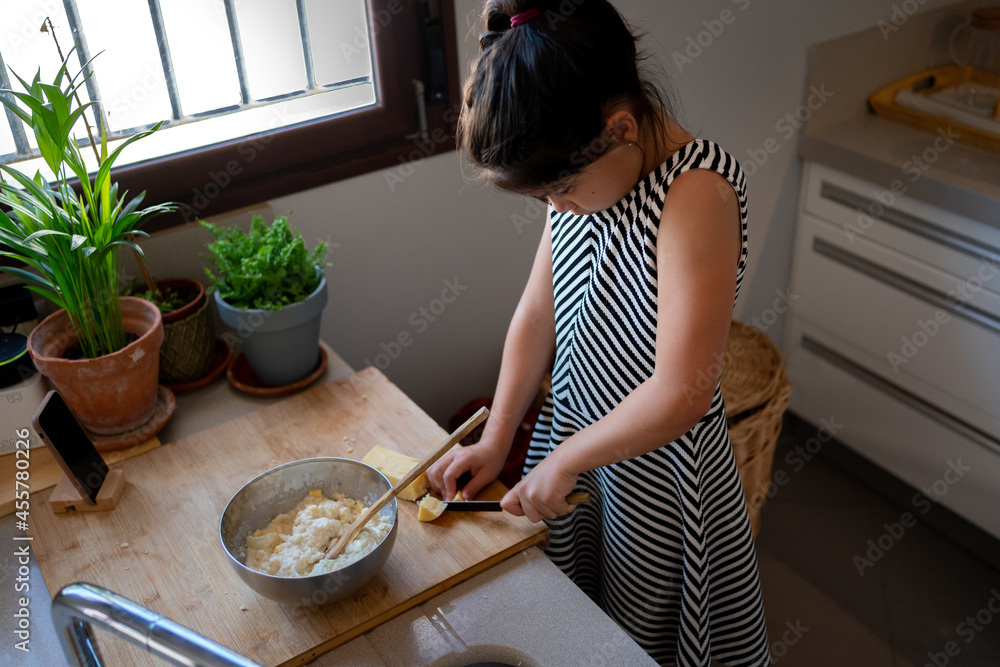 Child dicing cheese at home Stock Photo | Adobe Stock