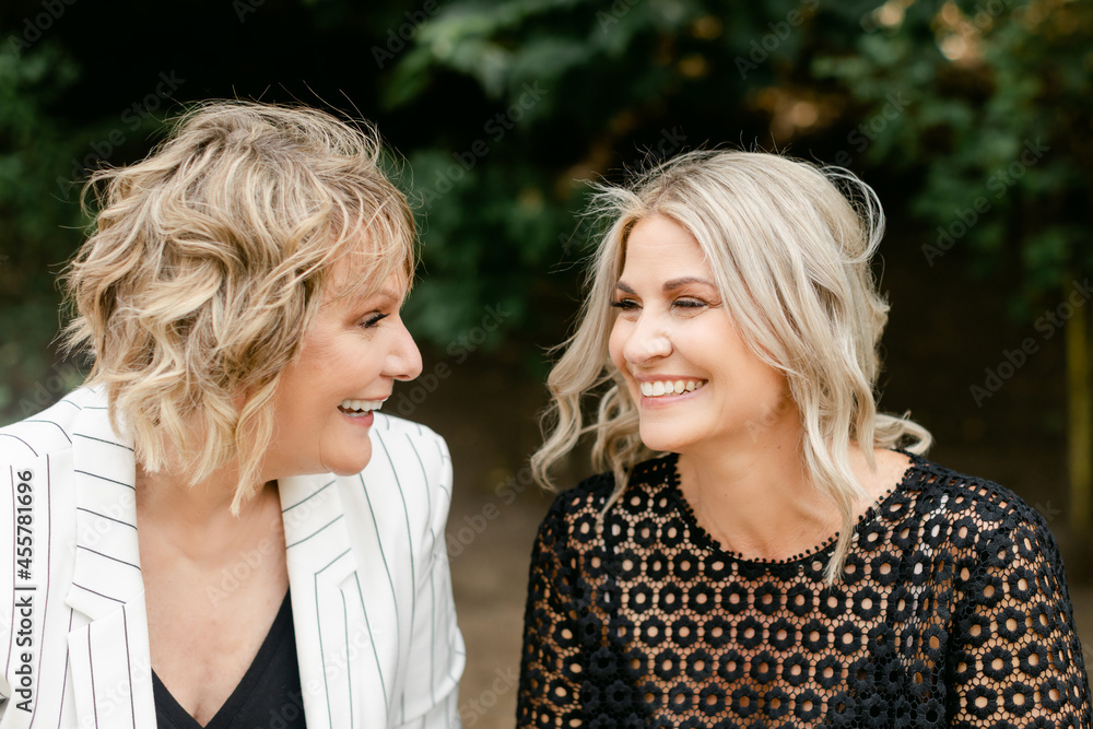Two Women Dressed Professionally Laughing Together Stock Photo | Adobe ...