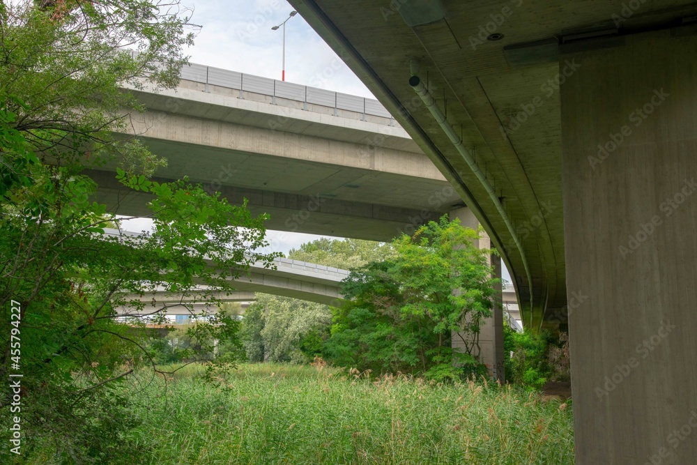 Highway exit ramps in green nature viewed from a low angle underneath ...