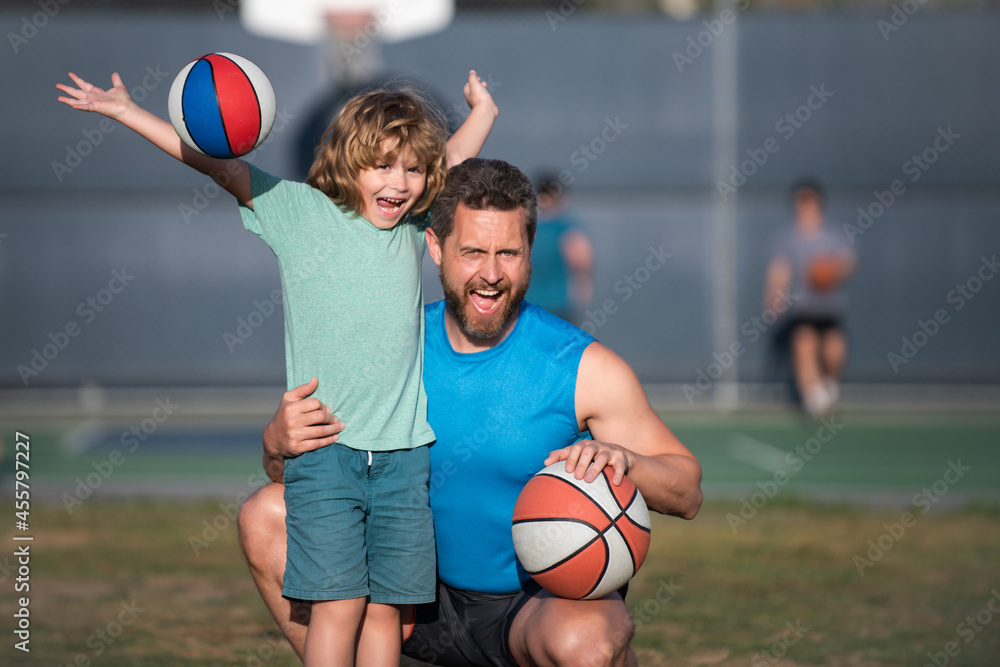 Cute boy with dad playing basketball. Dad and child spending time ...