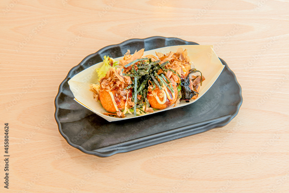 Octopus takoyaki battered with dried red tuna flakes, slices of nori ...