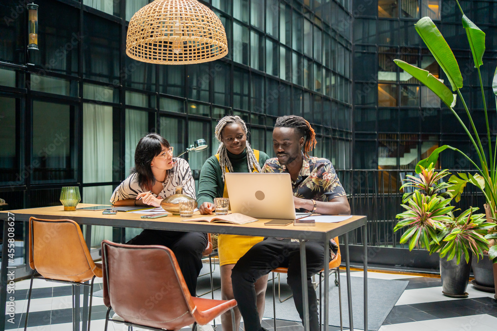 People Discussing Ideas Around The Table At Work. Stock Photo | Adobe Stock