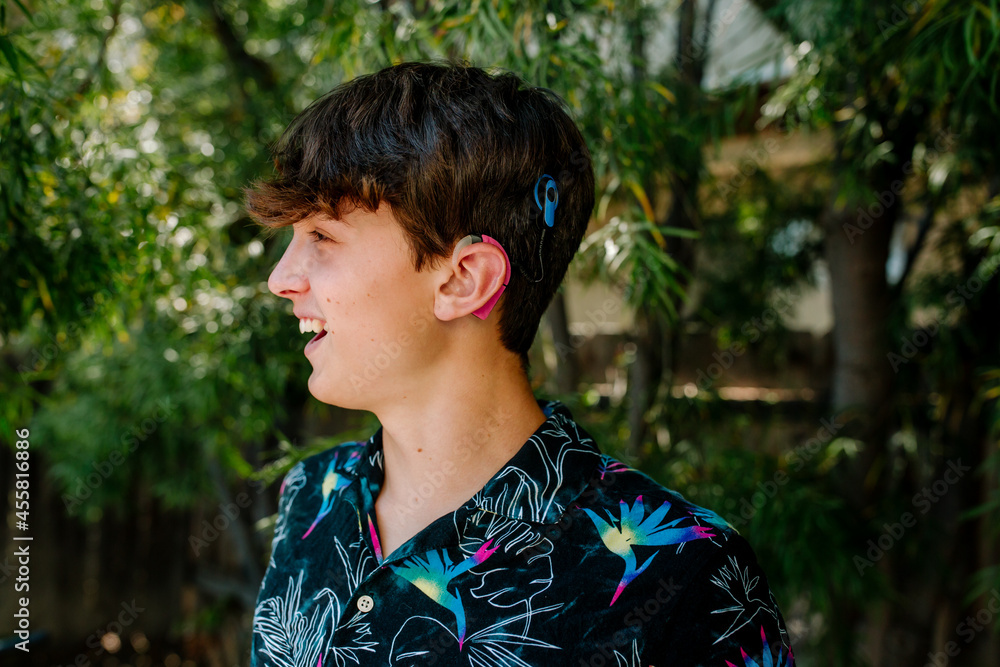 Smiling teen boy with hearing aids Stock Photo | Adobe Stock