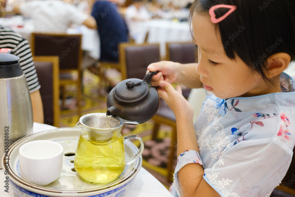 little girl making tea drink Stock Photo | Adobe Stock