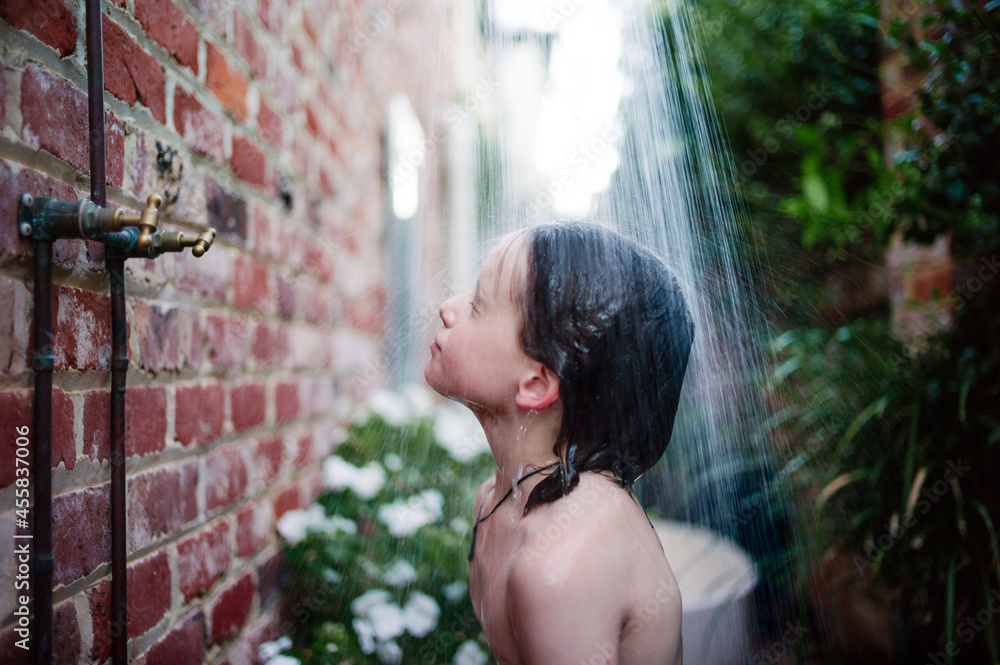 Child having an outdoor shower Stock Photo | Adobe Stock