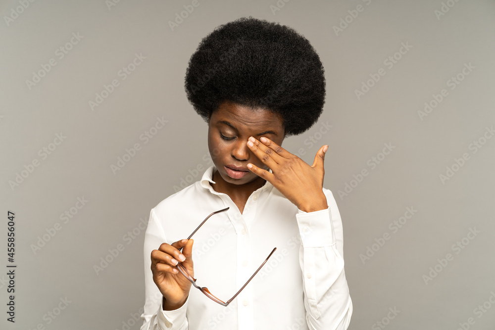 Sleepy young african business woman taking off glasses rubbing eyes ...
