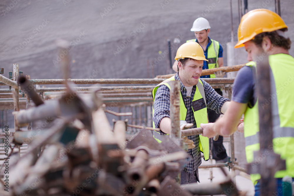 Constructor workers assembling rebar structure at construction site ...