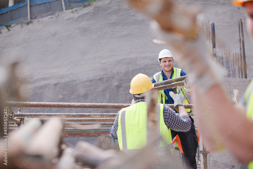 Constructor workers assembling rebar structure at construction site ...