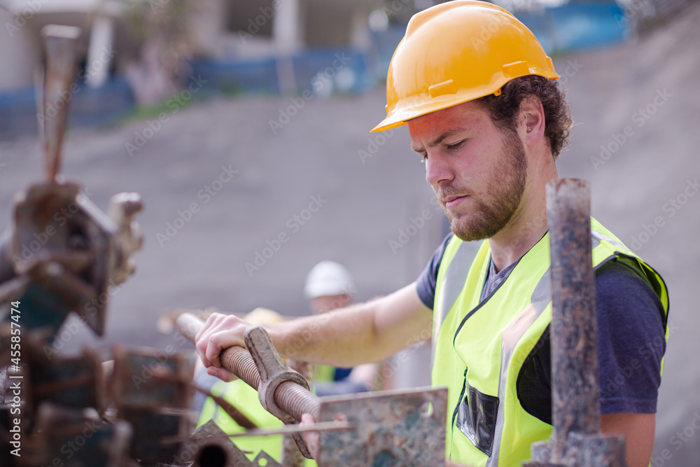 Constructor workers assembling rebar structure at construction site ...