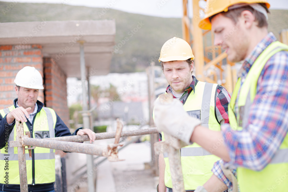 Constructor workers assembling rebar structure at construction site ...