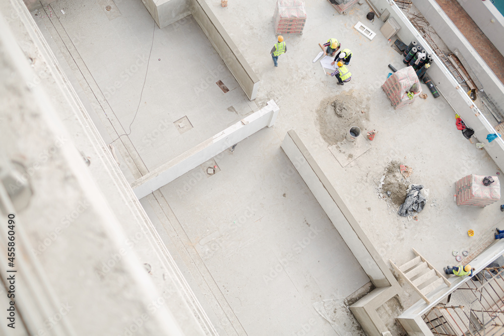 Overhead view of construction workers at construction site Stock Photo ...