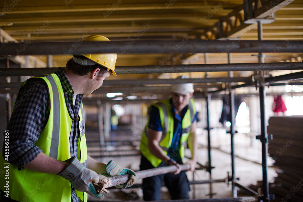 Constructor workers assembling rebar structure at construction site ...