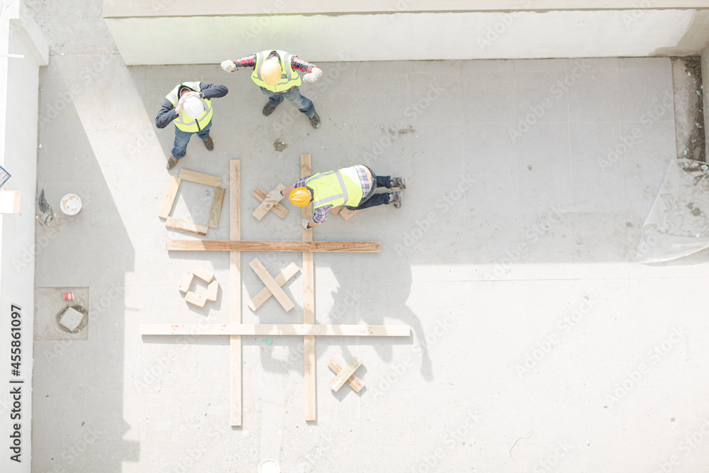 Overhead view of construction workers at construction site Stock Photo ...