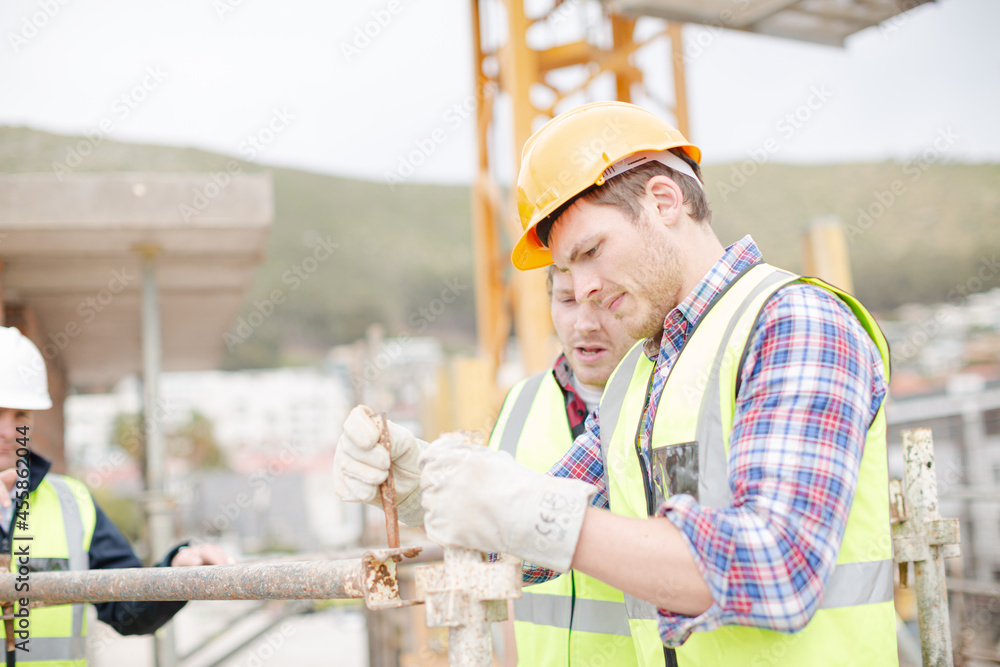Constructor workers assembling rebar structure at construction site ...
