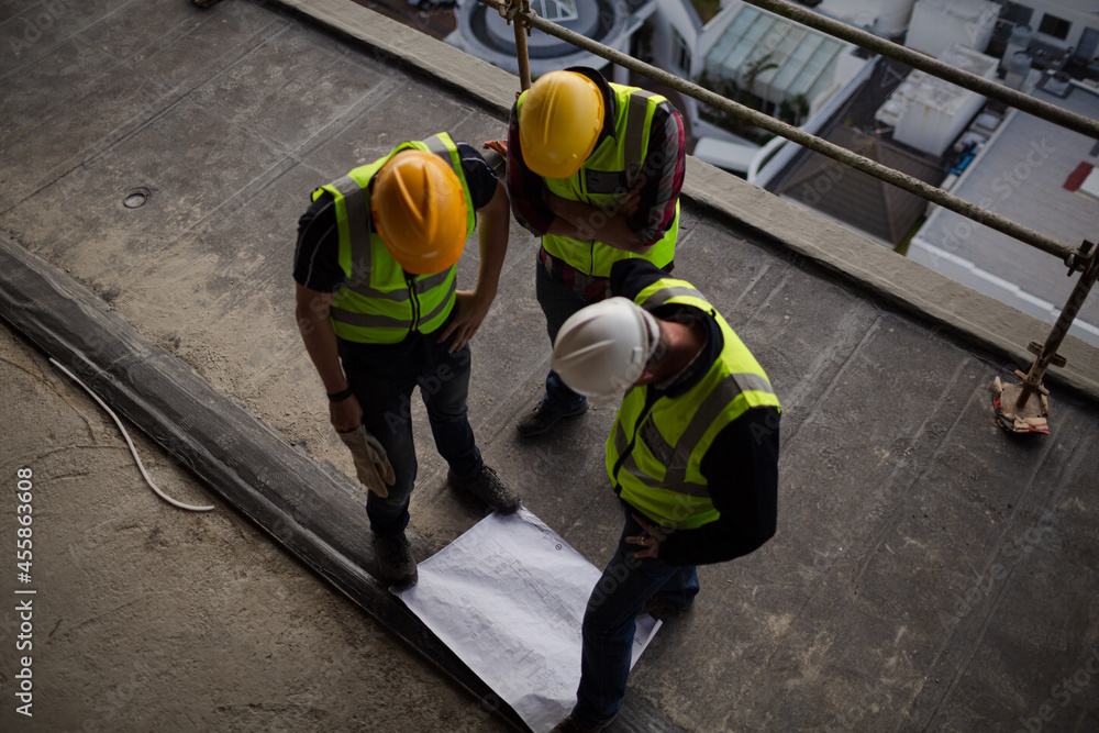 Overhead view of construction workers laying concrete at construction ...