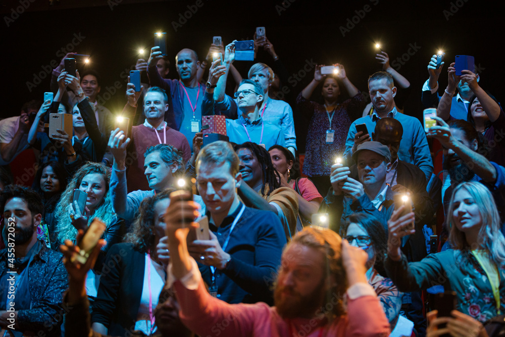 Smiling audience using smart phone flashlights for speaker Stock Photo ...