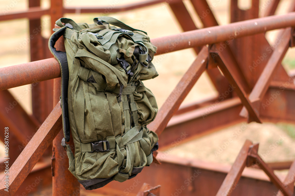 tourist backpack hanging on the railing of the old iron bridge over the ...