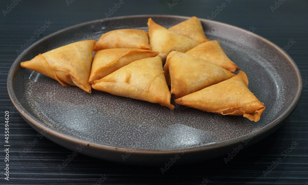 deep fried crispy yam taro spring roll samosa on dark grey wood ...
