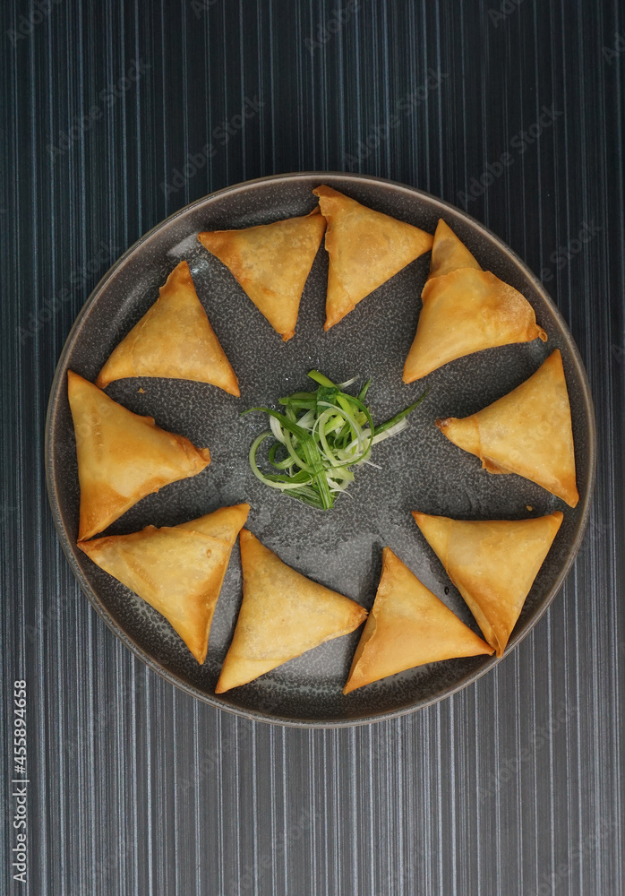 deep fried crispy yam taro spring roll samosa on dark grey wood ...