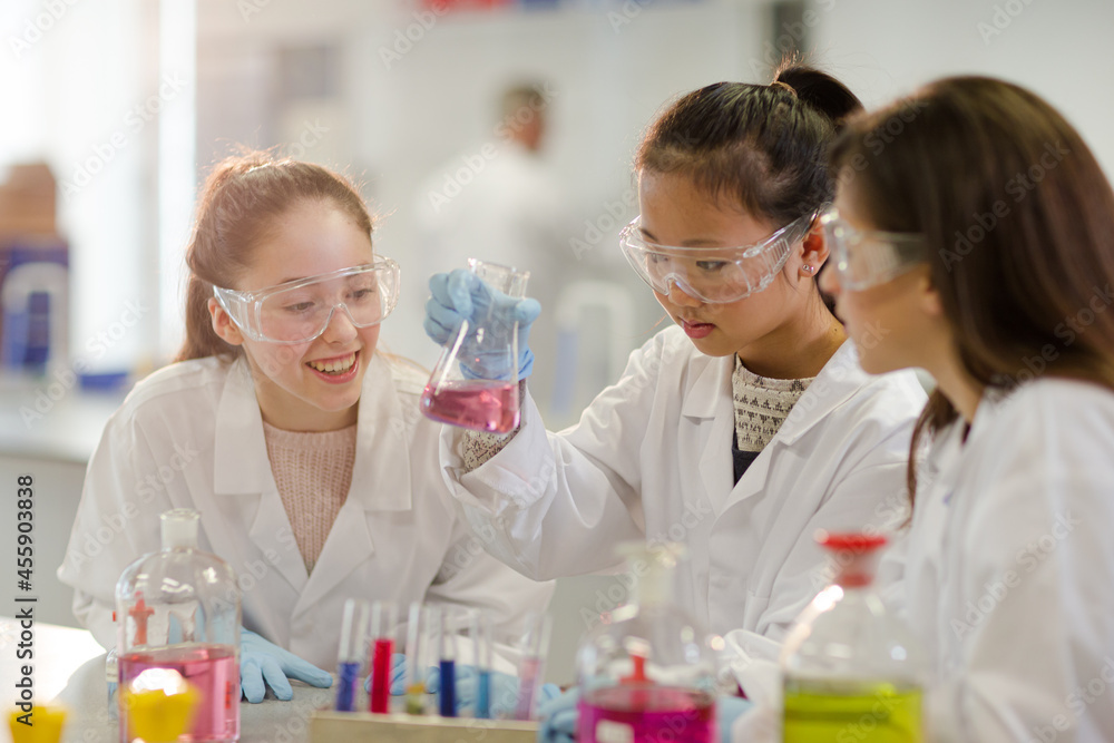 Girl students conducting scientific experiment in laboratory classroom ...