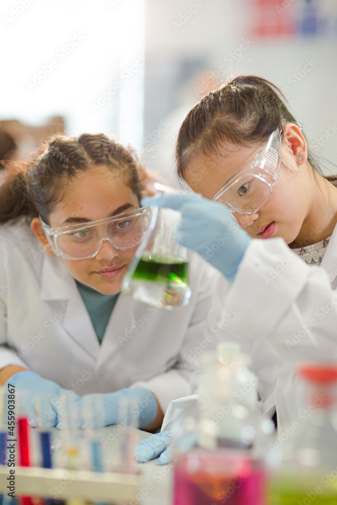 Students watching chemical reaction, conducting scientific experiment ...