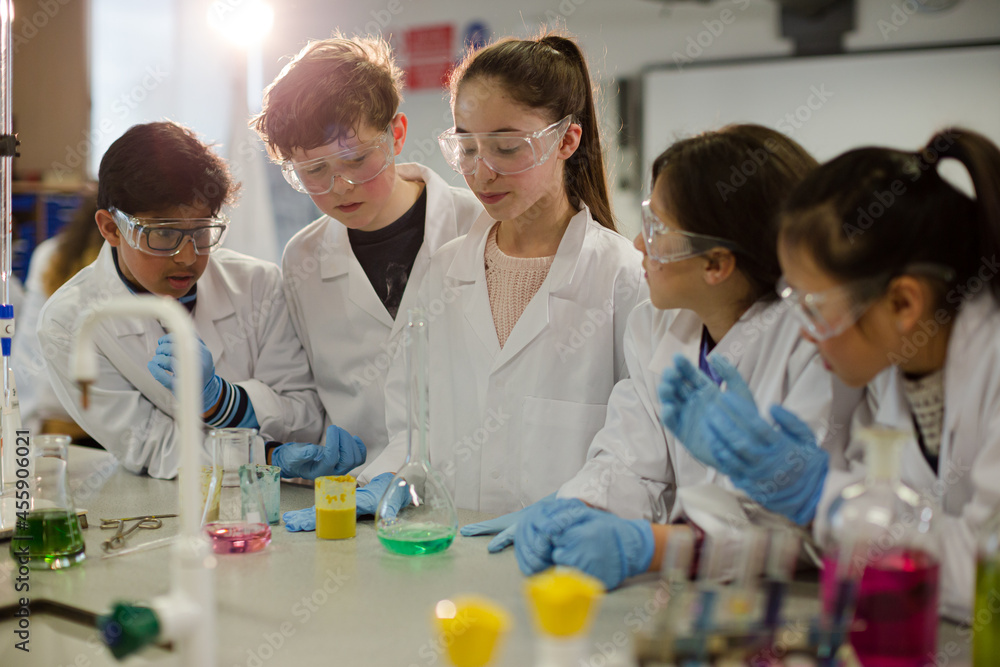 Surprised students conducting exploding foam scientific experiment in ...