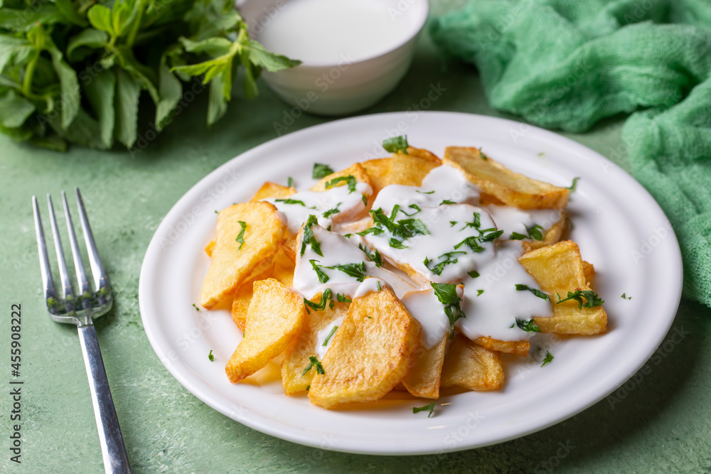 Traditional delicious Turkish foods, fried potatoes with yoghurt ...