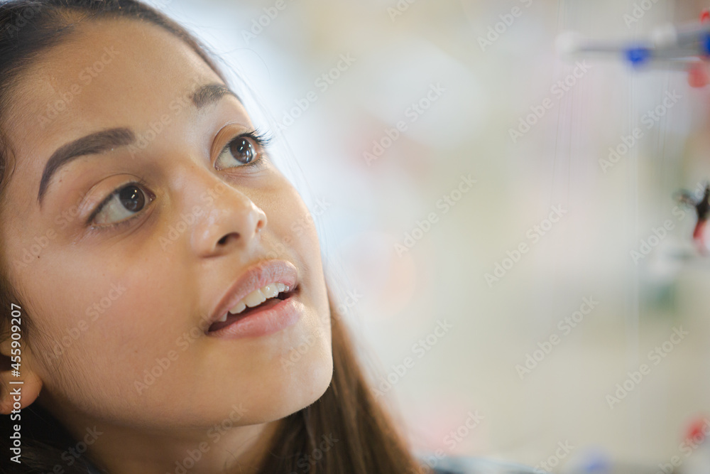 Curious girl student examining molecular structure Stock Photo | Adobe ...