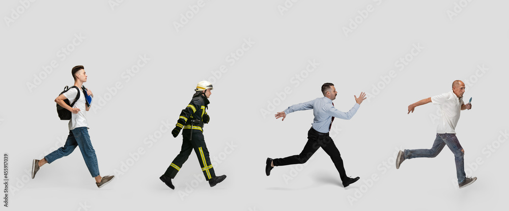 Full-length image of four different people running in a line isolated ...