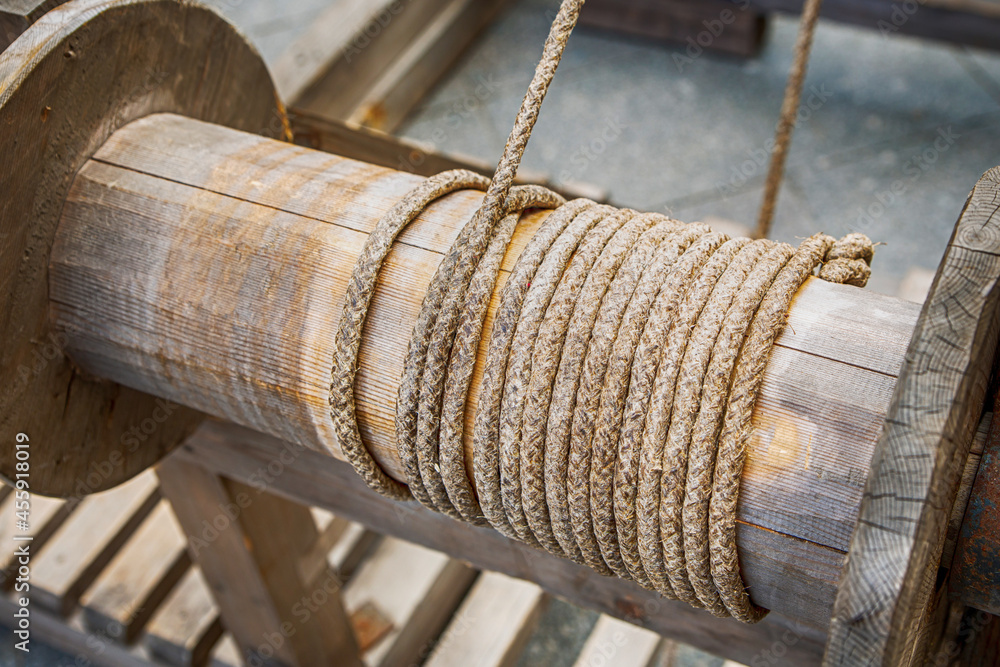 lifting mechanism of water from a well with a thick rope wound with a ...