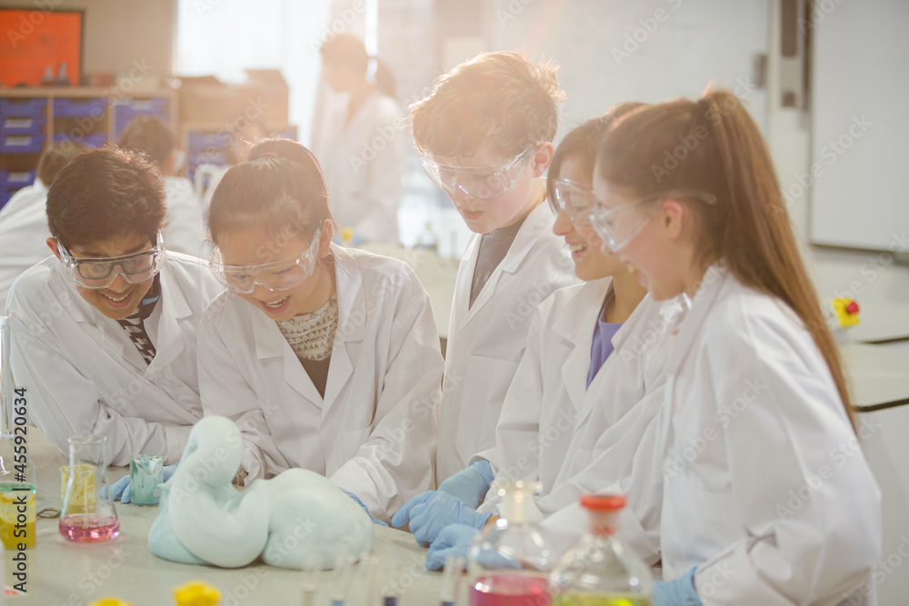 Surprised students conducting scientific experiment, watching chemical ...