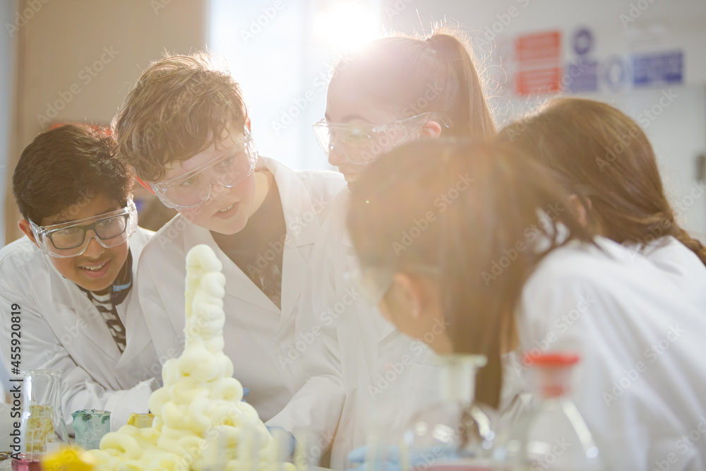 Surprised students conducting scientific experiment, watching chemical ...